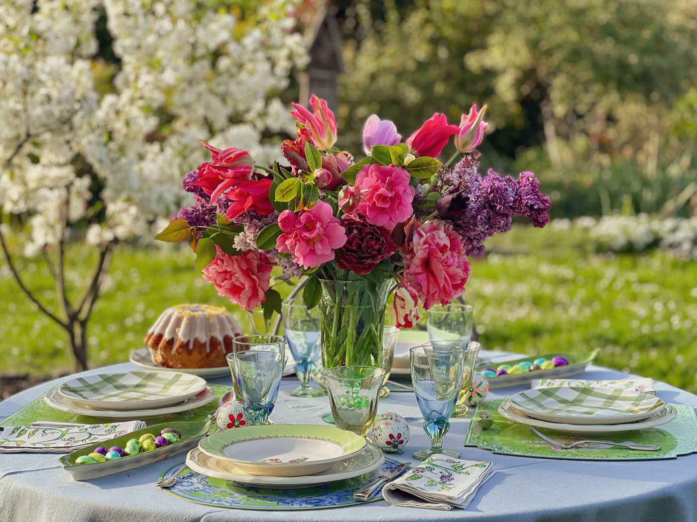 A French Easter table in the garden, beneath the blooming apple trees